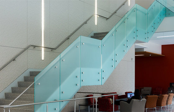 Glass railing with stainless steel standoff / patch fitting for staircase
