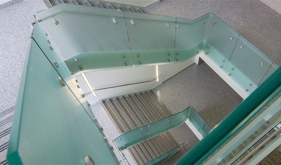 Glass railing with stainless steel standoff / patch fitting for staircase