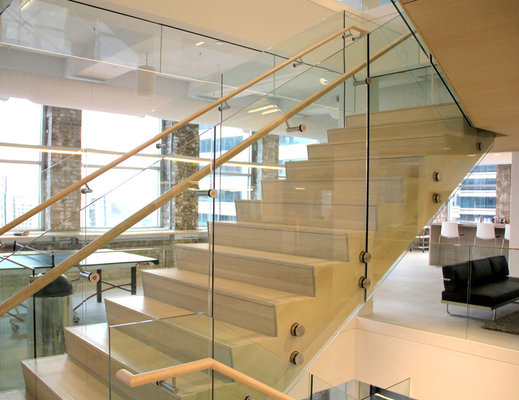 Glass railing with stainless steel standoff / patch fitting for staircase