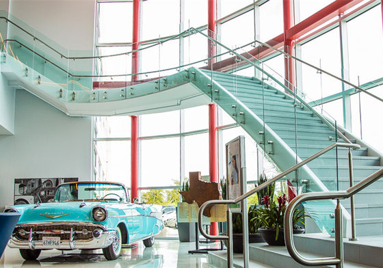 Glass railing with stainless steel standoff / patch fitting for staircase