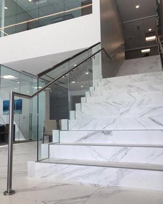 Stainless steel straight staircase with marble tread glass balustrade