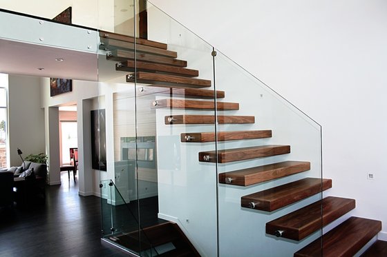 Interior glass wall railing floating staircase with wooden steps design
