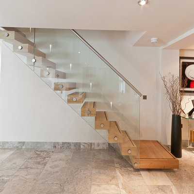 floating stairs with wooden tread and frameless glass railings