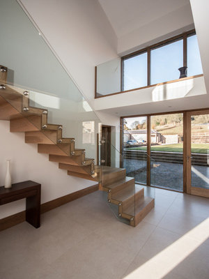 Clear glass railing floating stair with anti slip slots on steps
