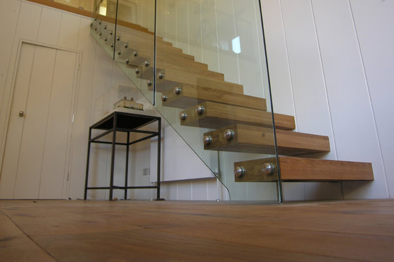 Clear glass railing floating stair with anti slip slots on steps