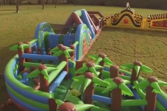 Giant inflatable amusement park or adventure park settle in plain & grassland for family