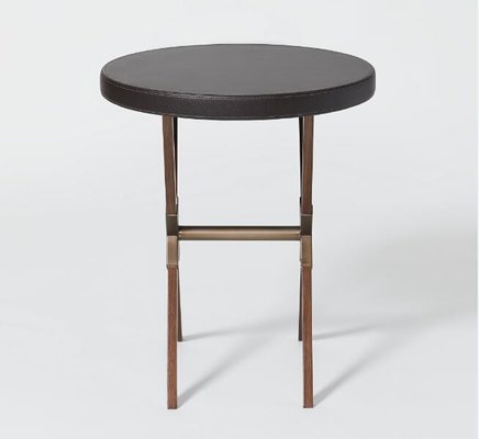 Antique brushed bronze metal base with upholstered leather top round hotel guestroom side table