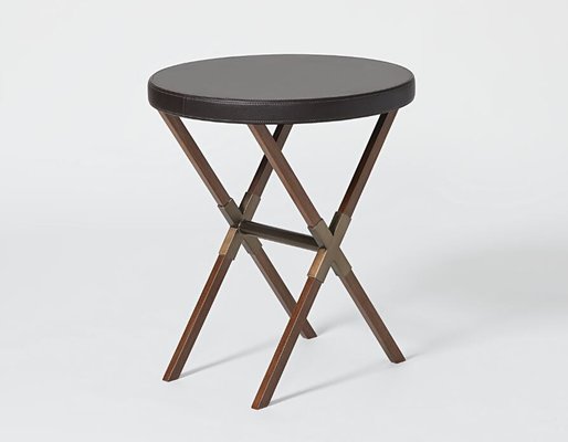 Antique brushed bronze metal base with upholstered leather top round hotel guestroom side table