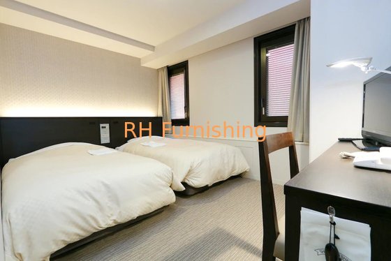 Lae standard twin room hotel furniture of wood headboard bed with long combine desk table and fabric chairs supplier
