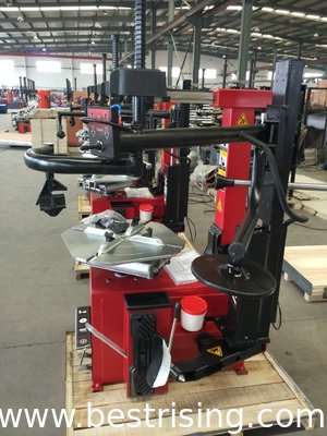 Tilting column pneumatic tire changer with helper arm
