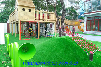 China Kindergarten wooden tree house outdoor playground equipment with climbing net supplier