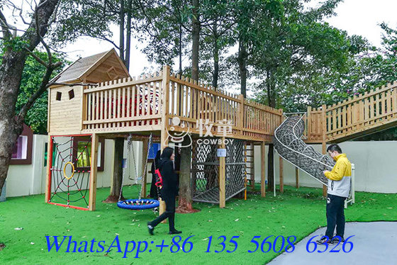 Kindergarten wooden tree house outdoor playground equipment with climbing net supplier