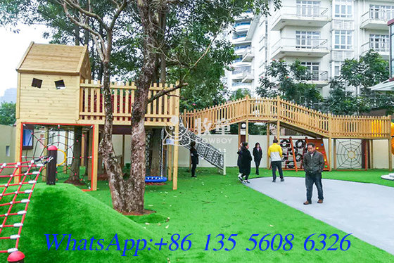 Kindergarten wooden tree house outdoor playground equipment with climbing net supplier