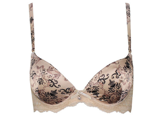 La jolie femme de sexe de mode capitonnée soulèvent le soutien-gorge floral de dentelle de satin de soutiens-gorge
