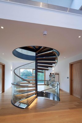 Stainless steel spiral staircase with wood steps and glass railing indoor glass spiral staircase